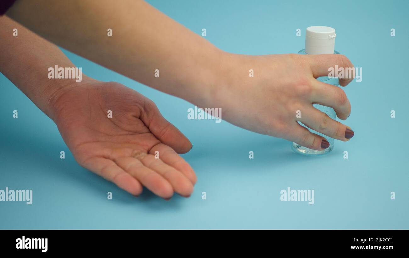 Alcohol gel for hand wash on blue background. Protection against ...