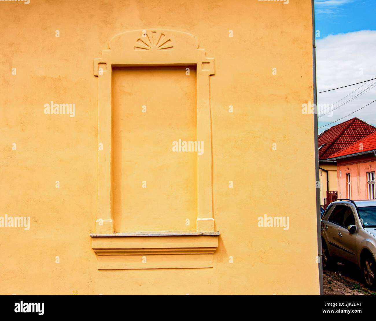 Decorative window on an old yellow plaster wall Stock Photo - Alamy