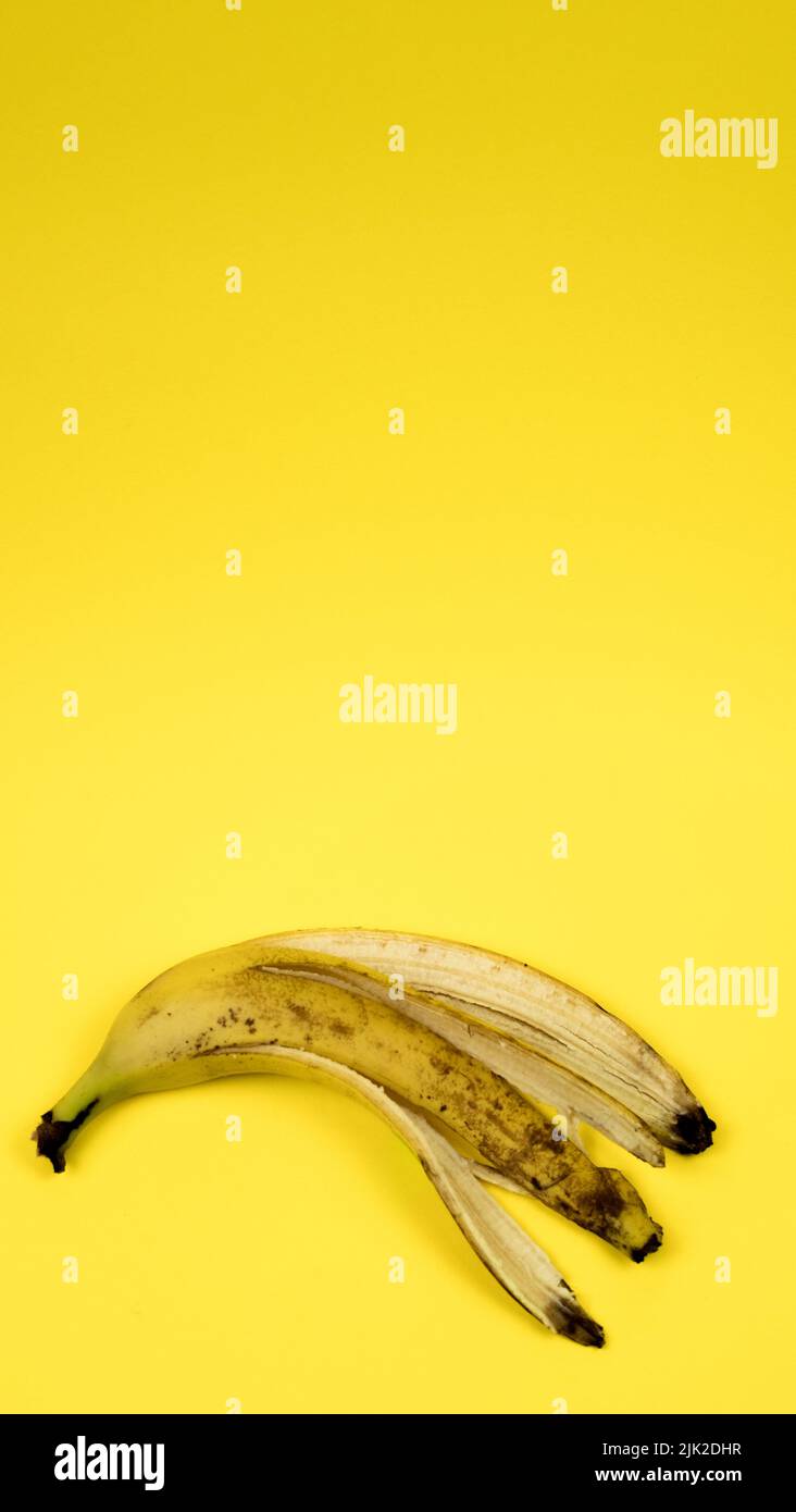 banana peel on yellow background, copy space, vertical photo Stock ...