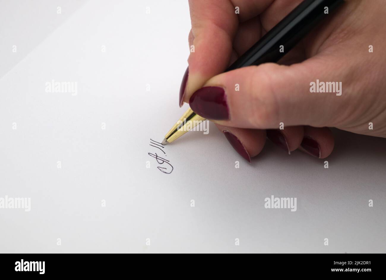 Female hand signing business papers. Close-up of woman signing document ...