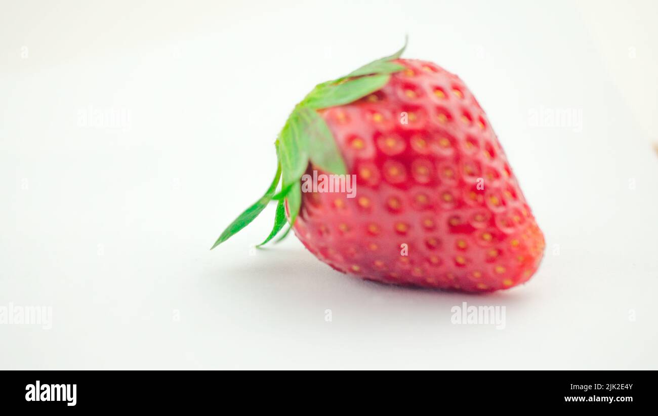 Red berry, one strawberry on white background Stock Photo - Alamy