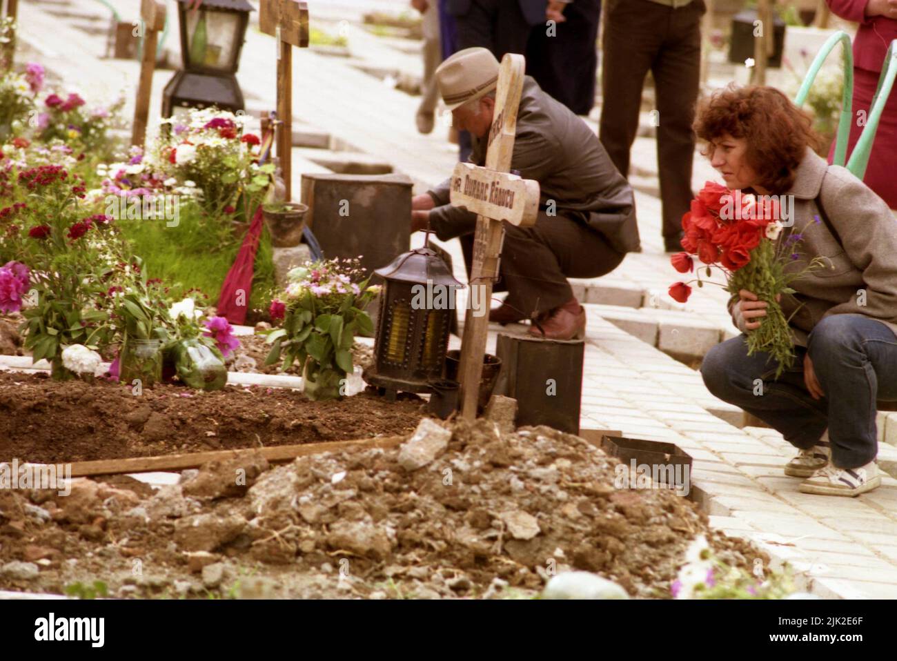 Bucharest, Romania, 1990. People in the cemetery of the heroes of the ...