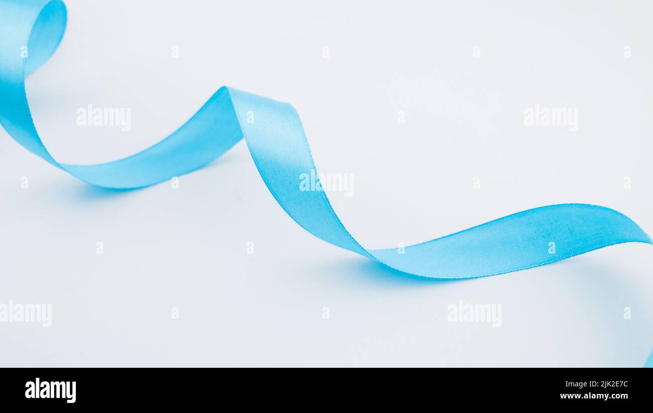 closeup of blue ribbon on white background Stock Photo - Alamy