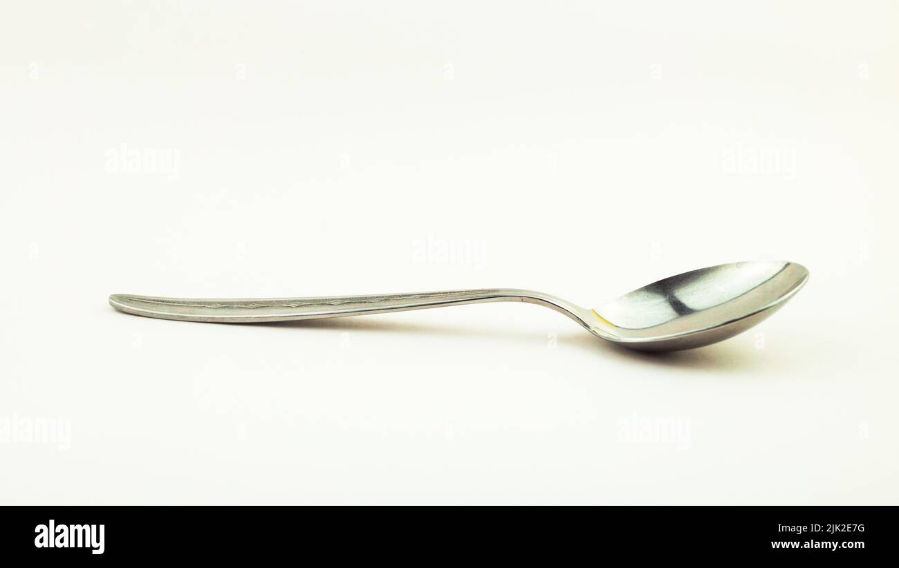 stainless steel spoon isolated on white background Stock Photo - Alamy