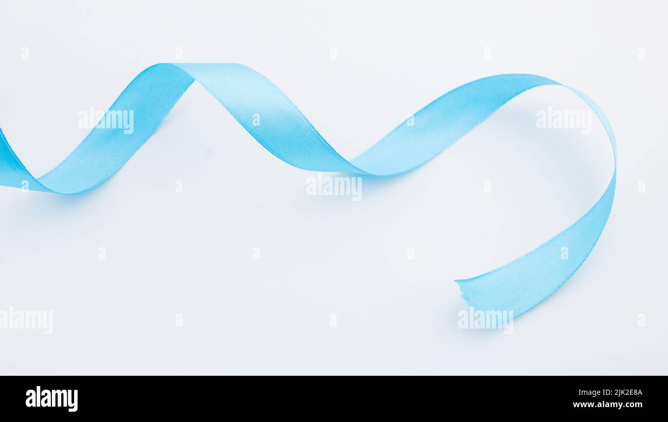 closeup of blue ribbon on white background Stock Photo - Alamy