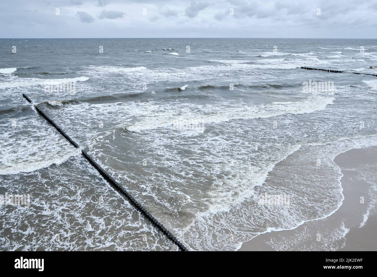 Seaside of Baltic Sea in Poland. Stormy sea, with waves hiting wooden ...