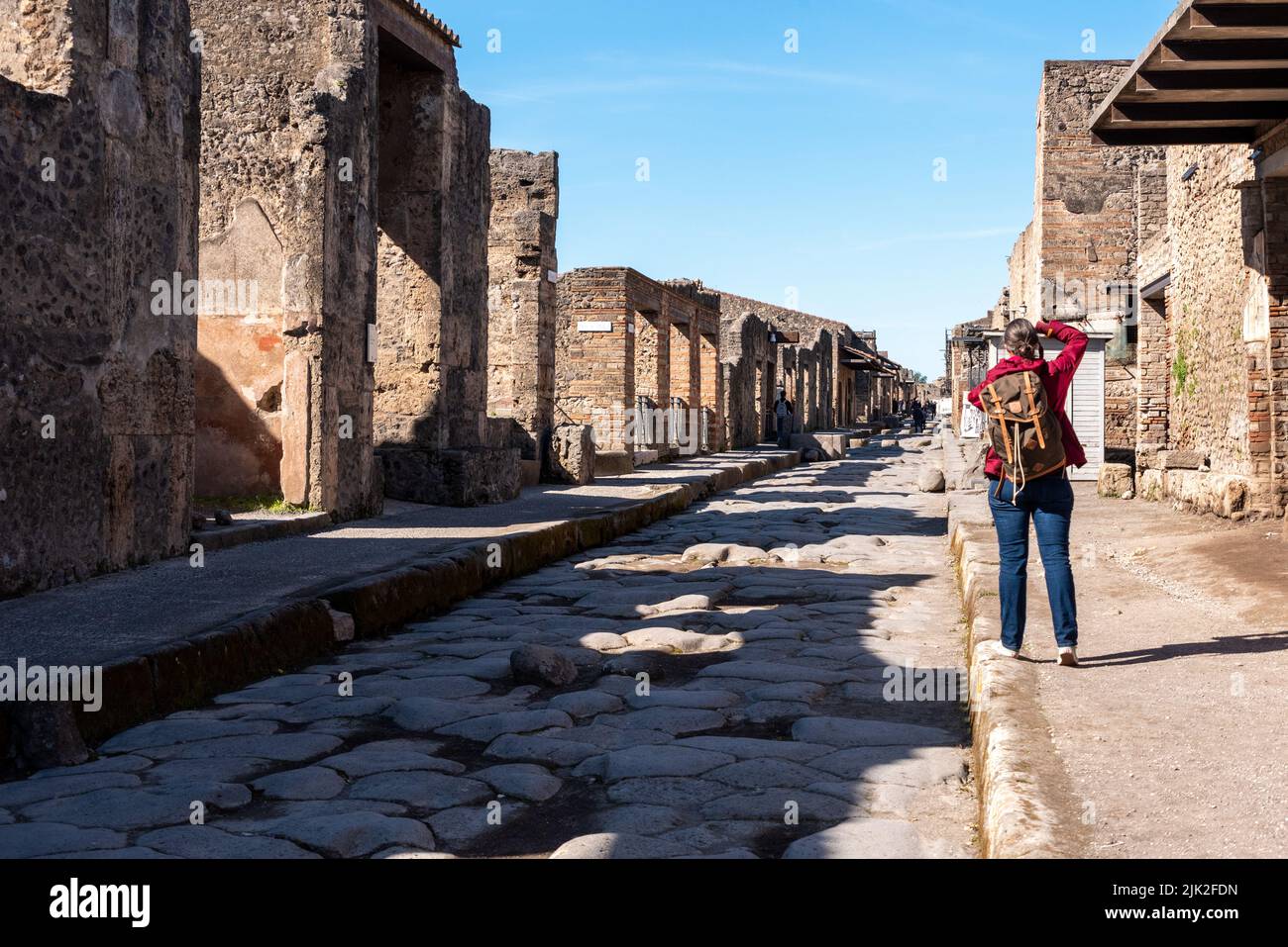 Tourist at typical roman cobbled road in ancient pompeii hi-res stock ...