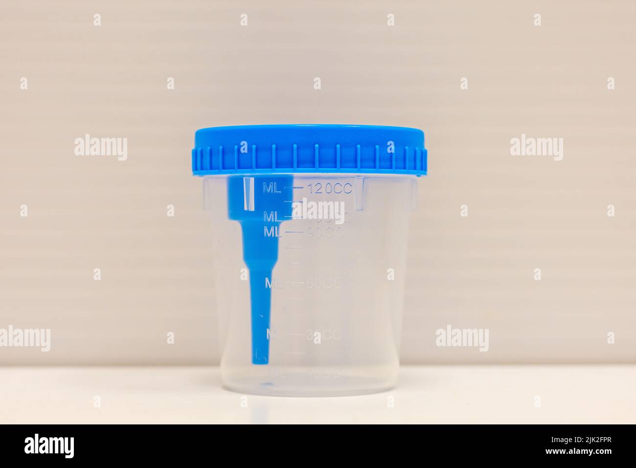 Bottle with a blue lid for collecting urine samples for analysis in the ...