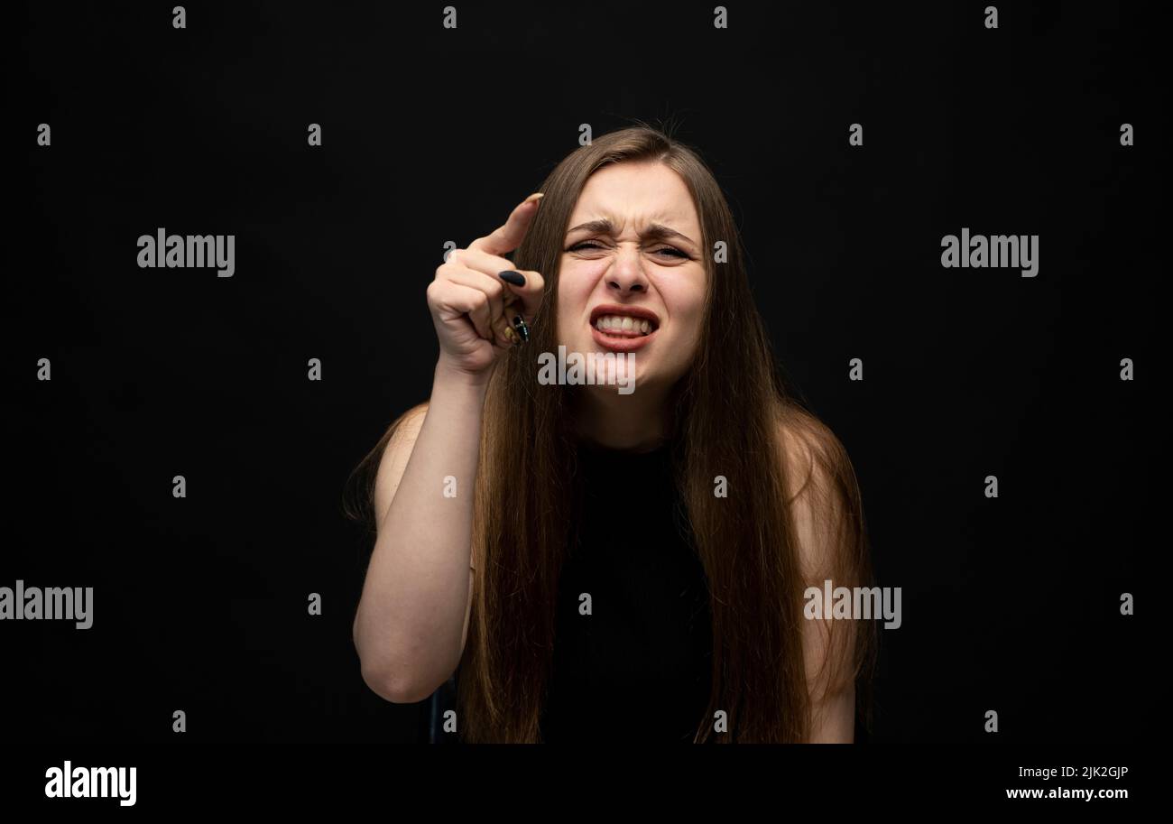 Negative human emotions and feelings. Grumpy angry young woman posing ... Negative human emotions and feelings. Grumpy angry young woman posing ...