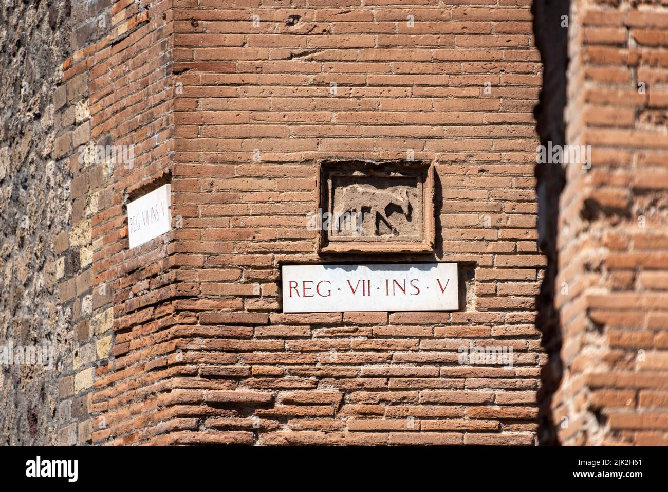 Sign with the street's name in ancient Pompeii and a fresco decoration ...