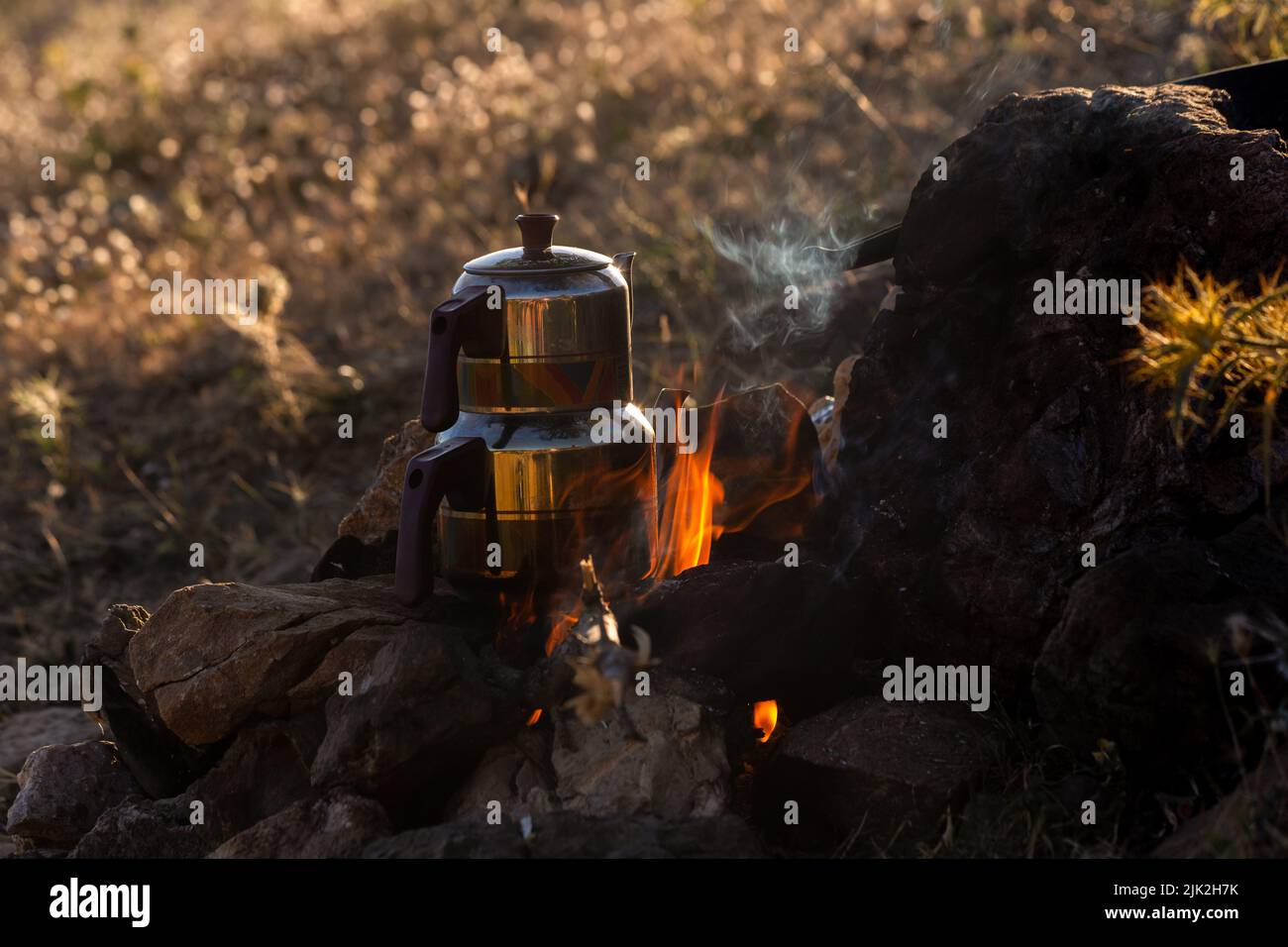 Brewing tea on a campfire and smoke from the fire Stock Photo - Alamy