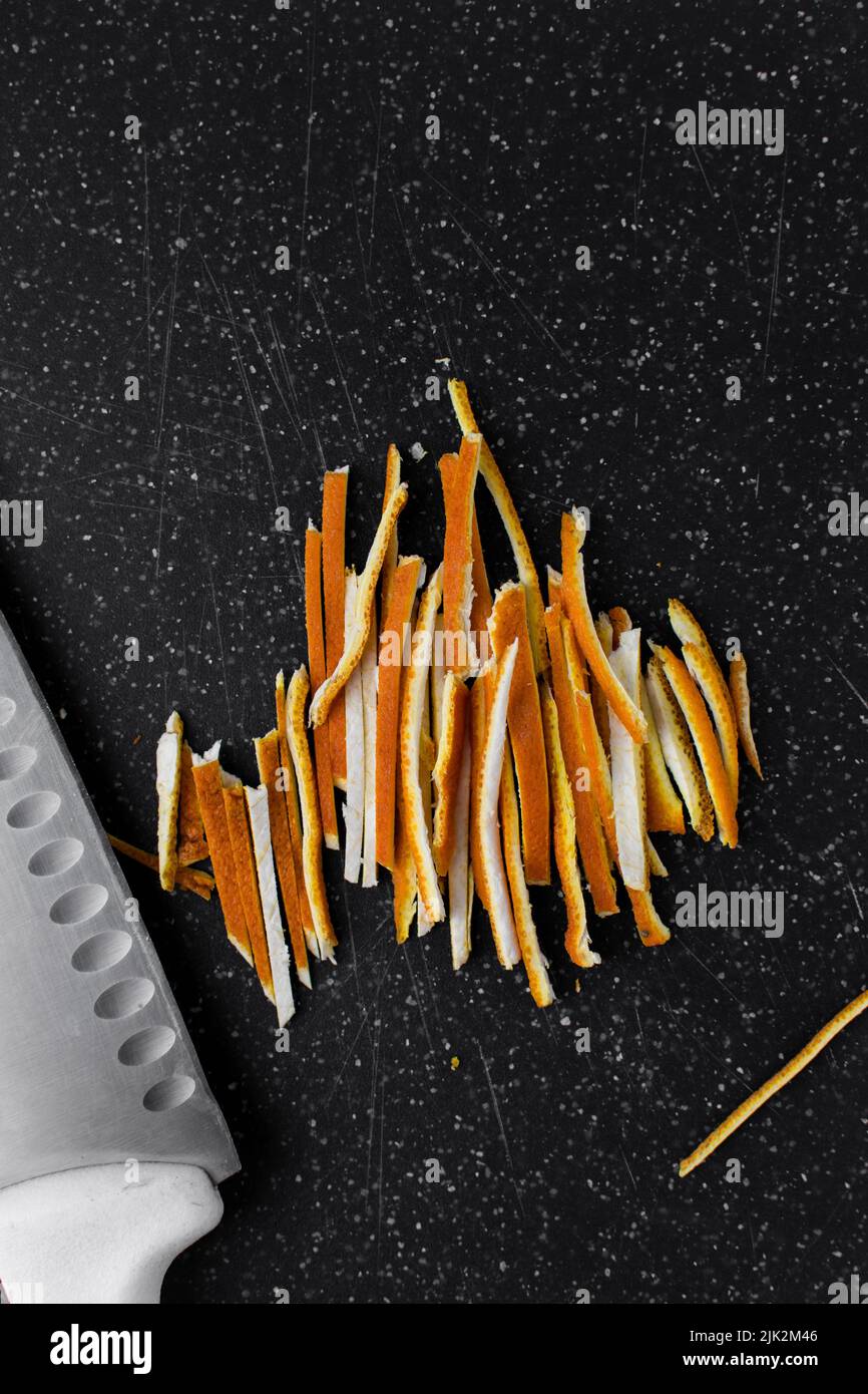 Orange rind thinly sliced, julienned orange rind on cutting board ...