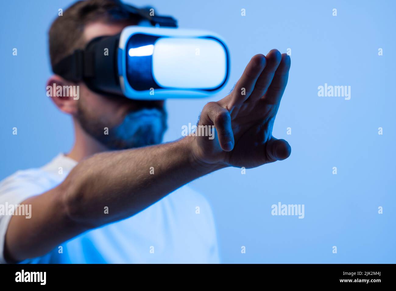 European man's in VR-glasses in neon. Concept of modern gadgets and ...