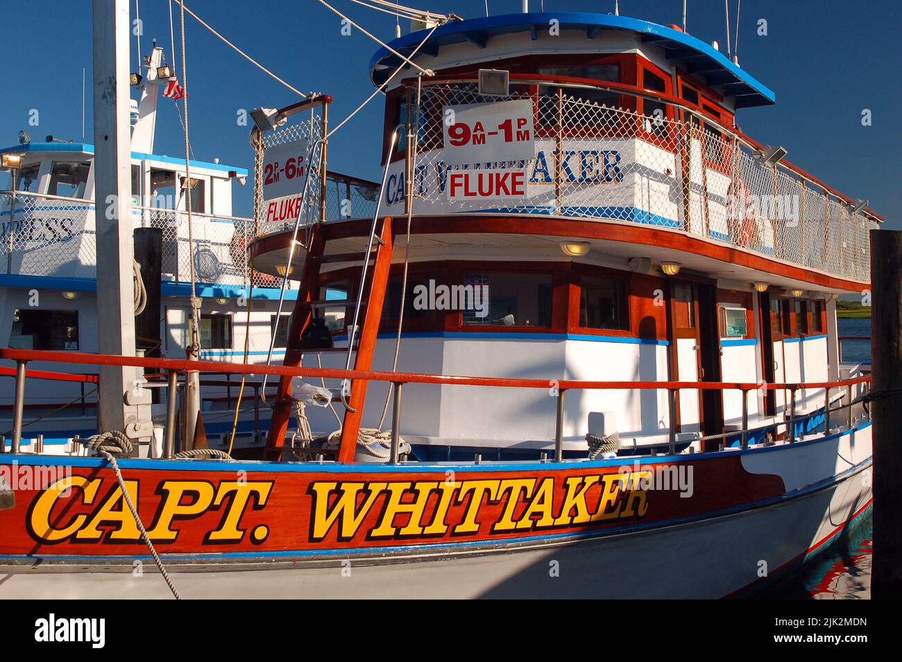 A charter fishing boat is docked on a pier in Captree State Park, Long ...