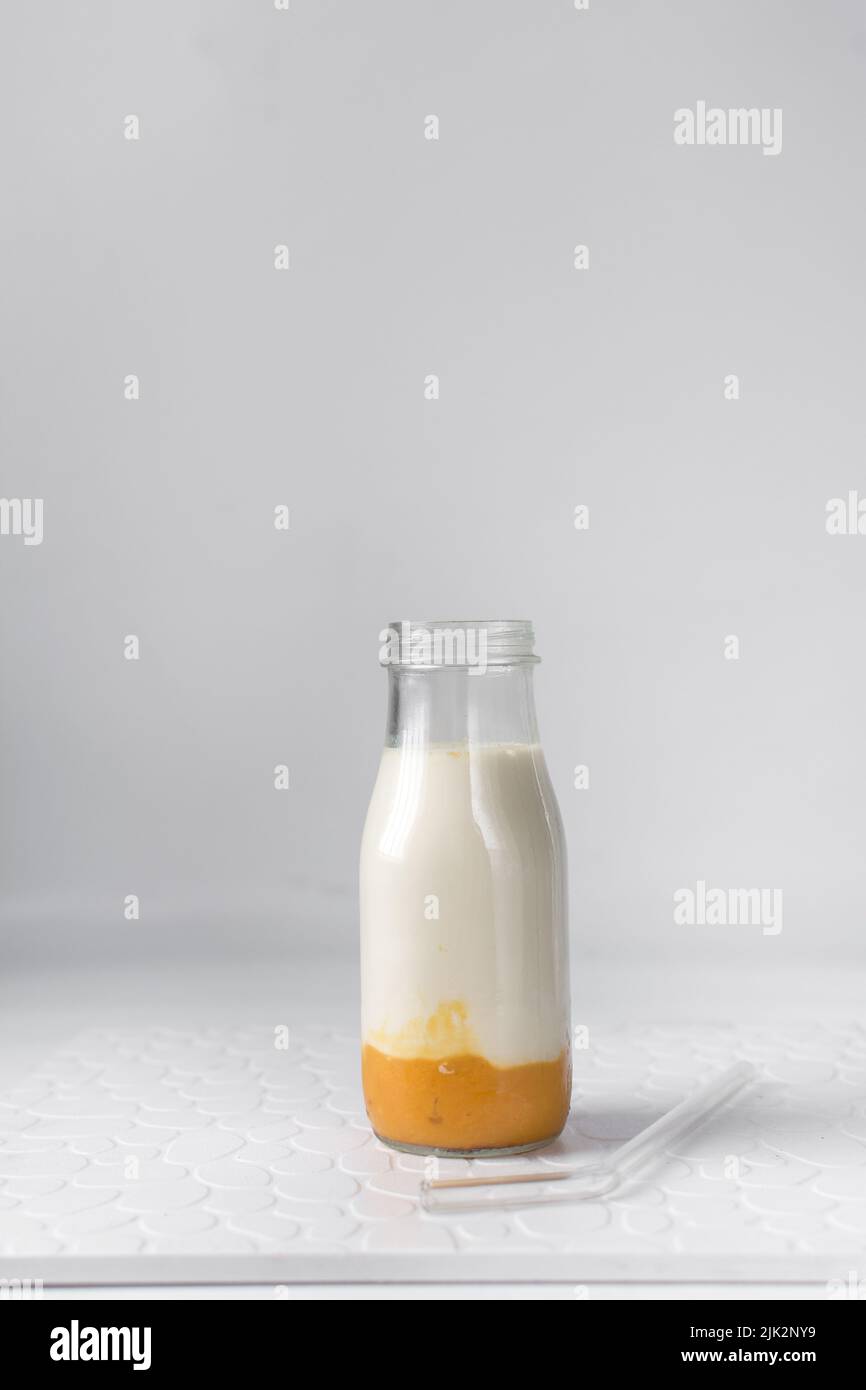 Mango milk in a classic milk bottle, mango puree and whole milk in a ...
