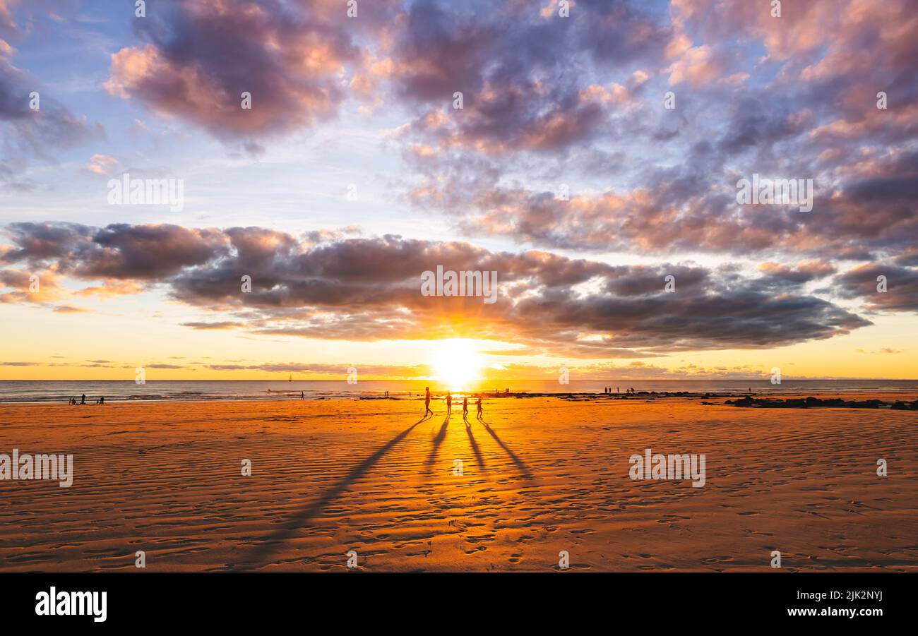 A family enjyoing beautiful sunset, sky, beach, and summer fun at Cable ...