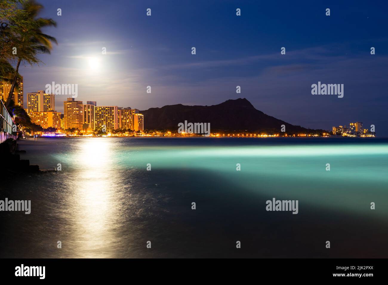 Beautiful night view of sky, diamondhead, beach, and moon in Waikiki ...