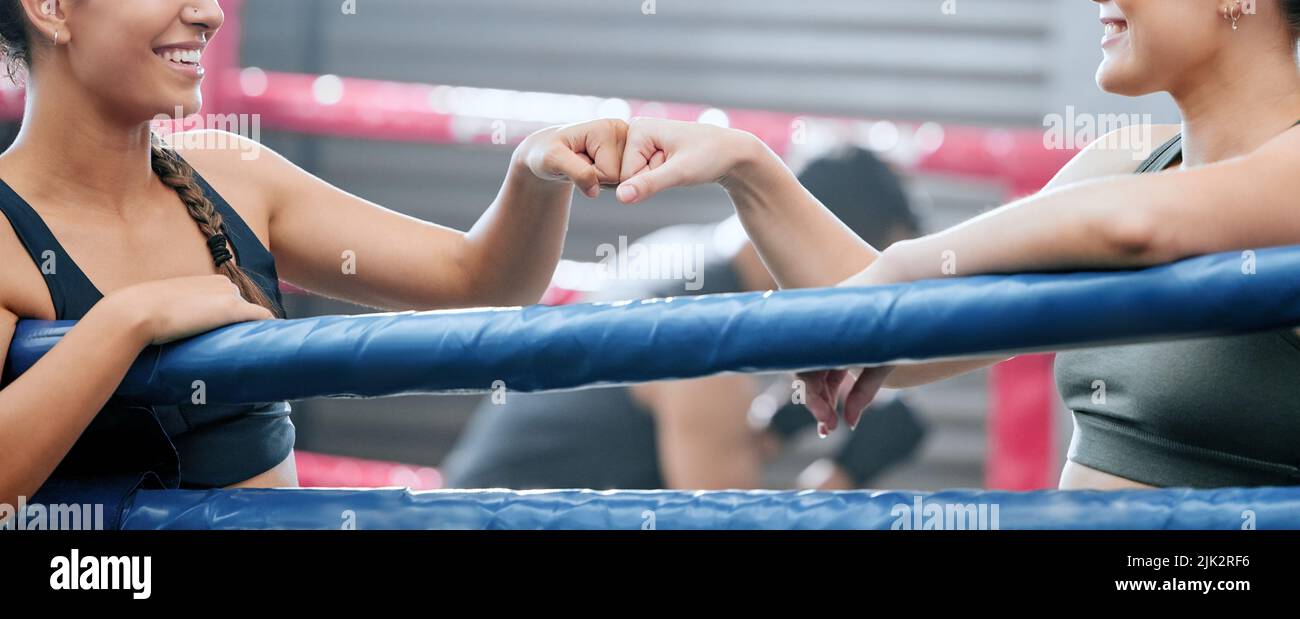 Closeup of happy women showing support, motivation and unity with fist ...