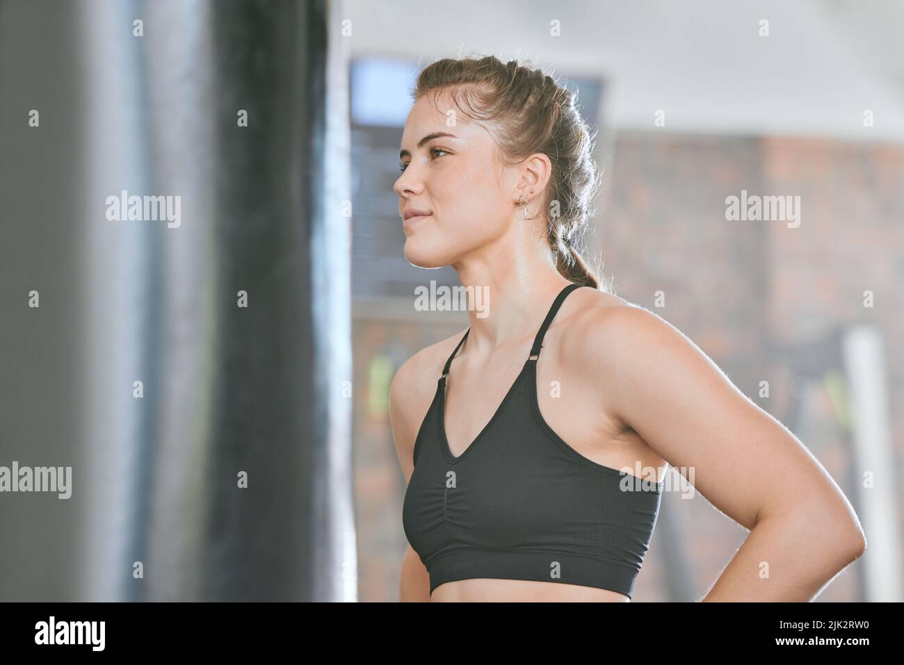 Healthy, fit and active female boxer thinking about a fight ...