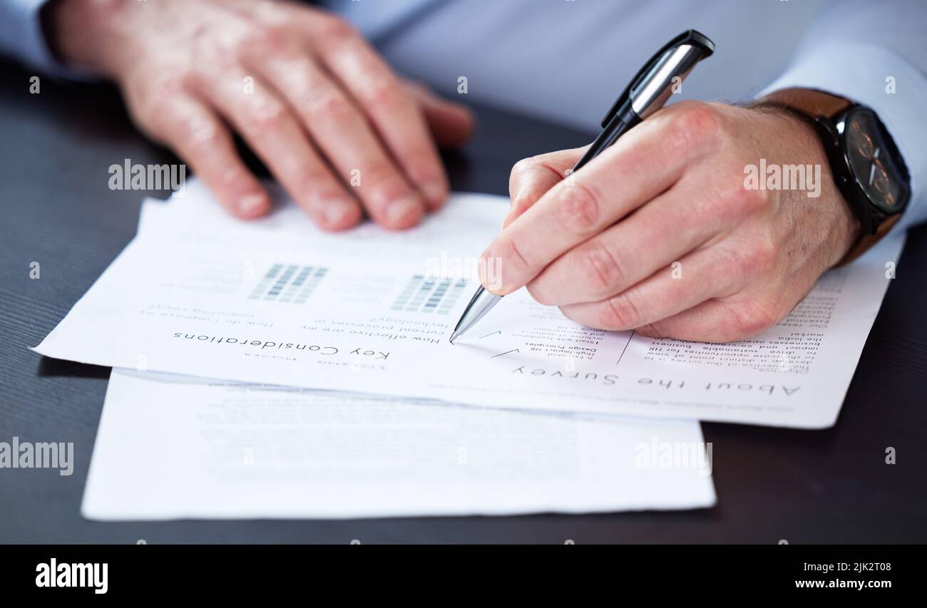 So many documents to sign. an unrecognizable businessperson going ...