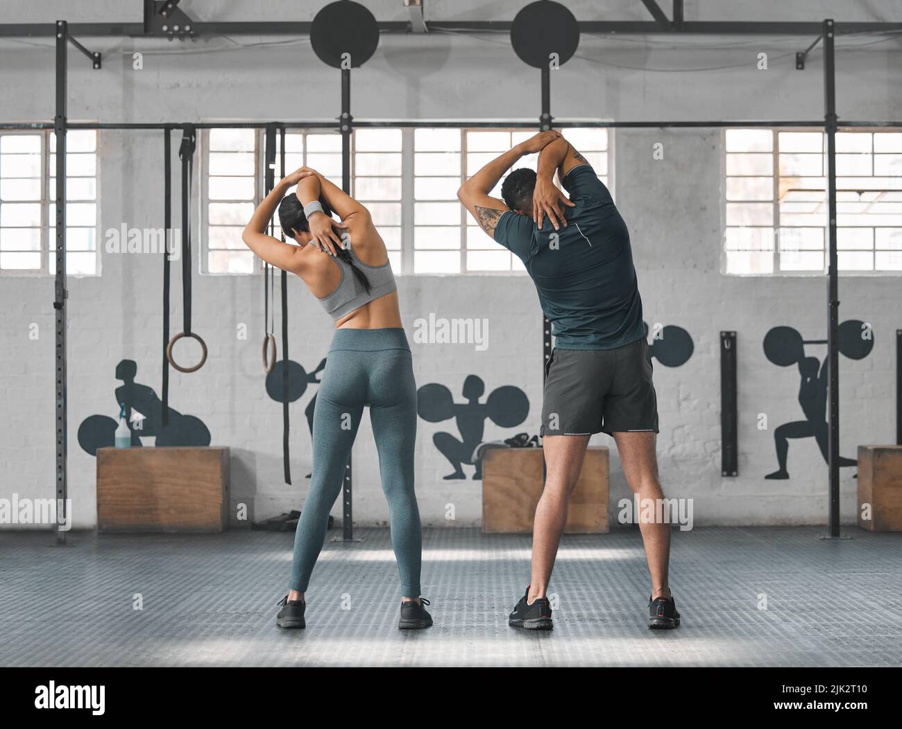 Fit, active and healthy gym couple stretching, getting ready and ...