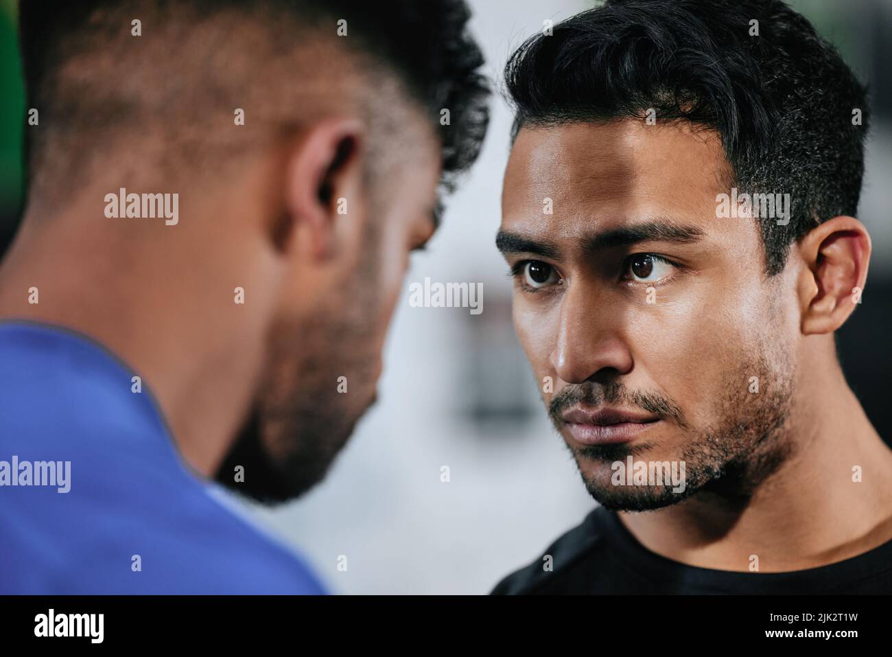 Serious, strong and fit male athletes staring, facing and looking tough ...