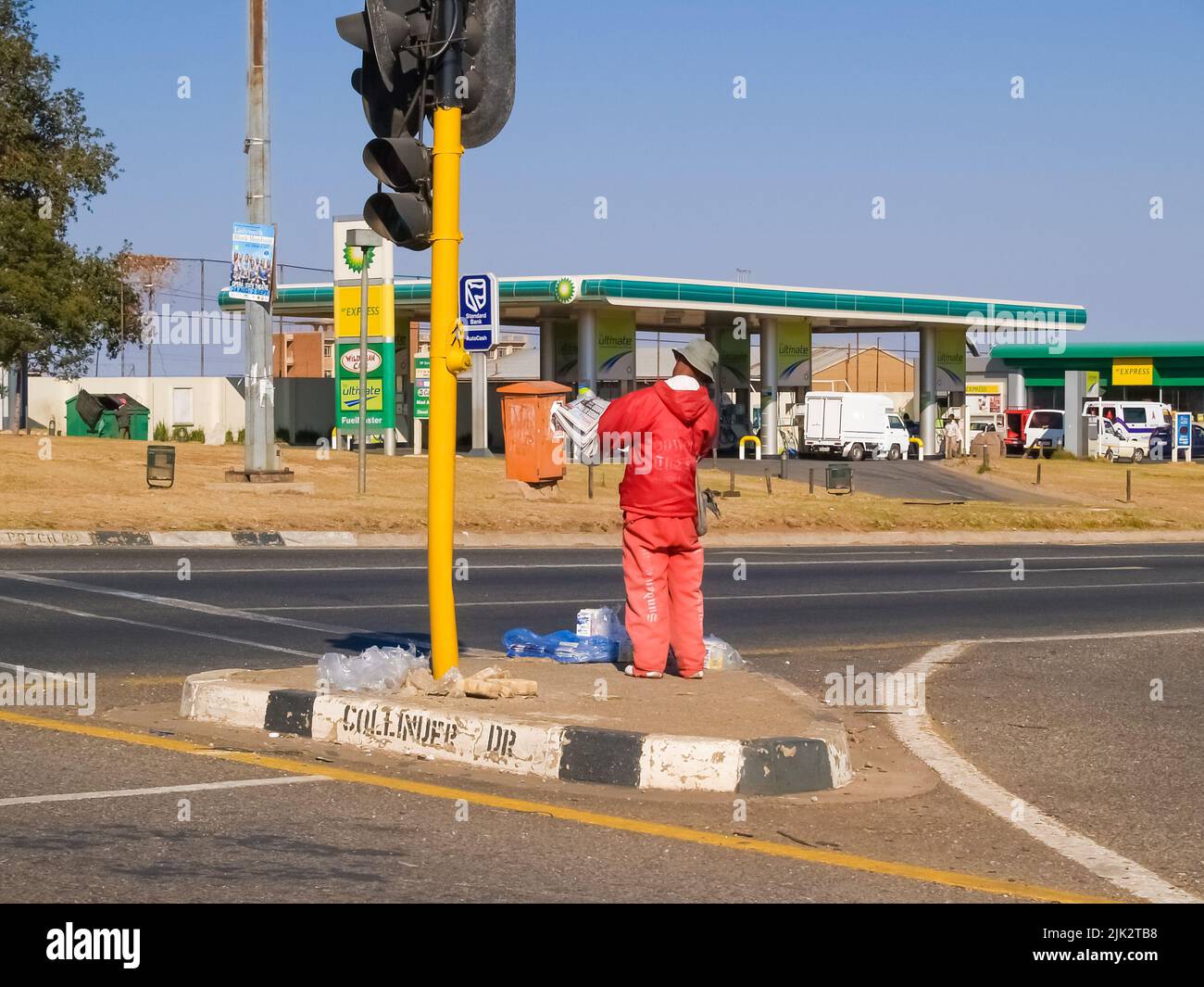 August 15 2007 in Soweto South Africa; African man in red standing in ...