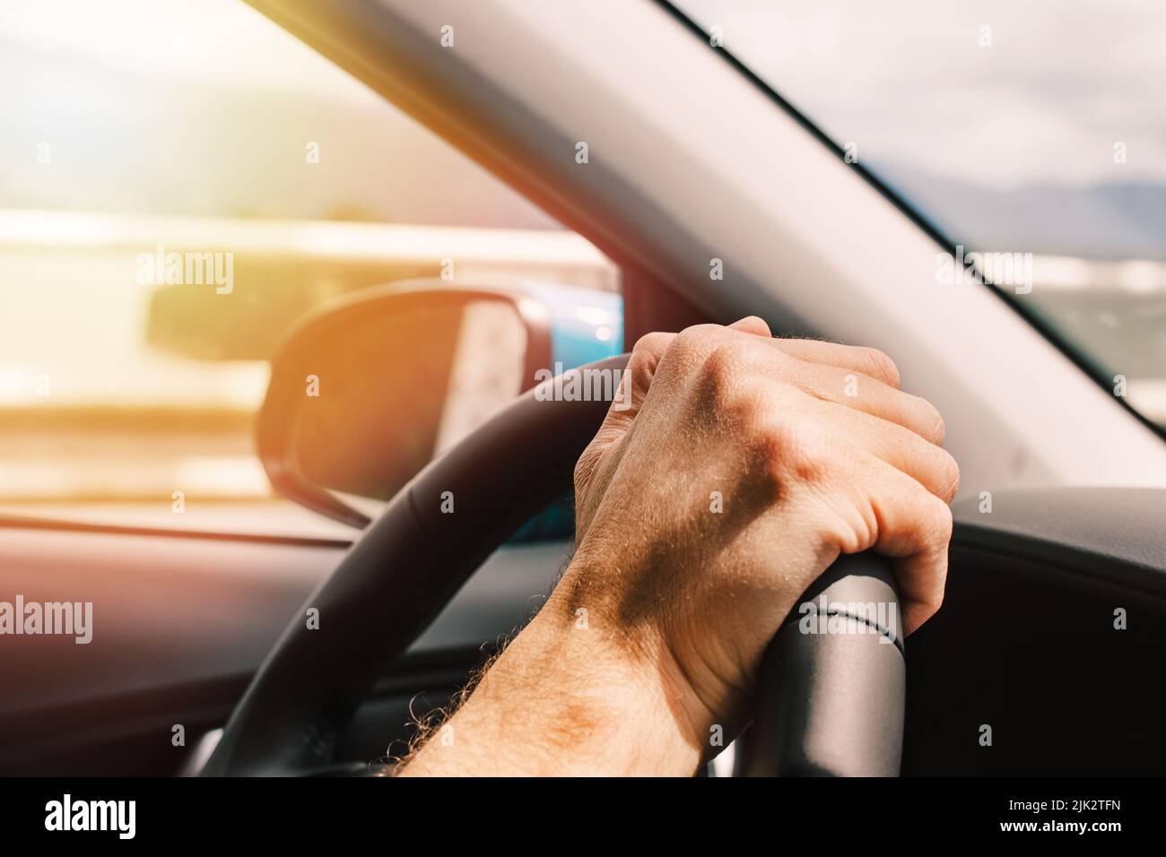 Mans hand steering wheel hi-res stock photography and images - Alamy