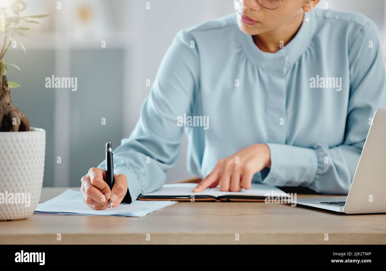 Serious finance manager writing notes, planning and checking financial ...