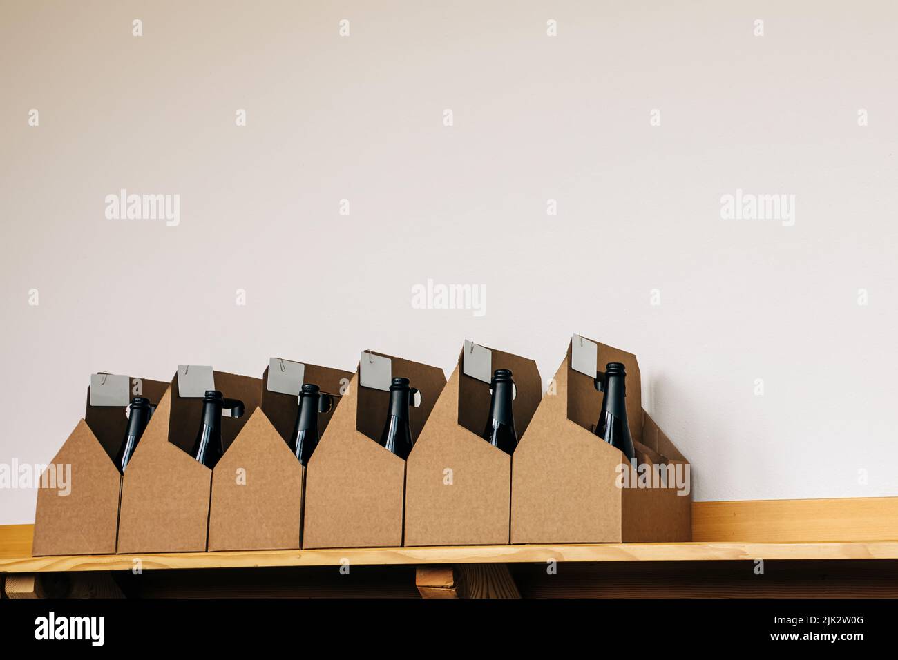 Cardboard boxes with bottles of wine standing on the shelves in the ...