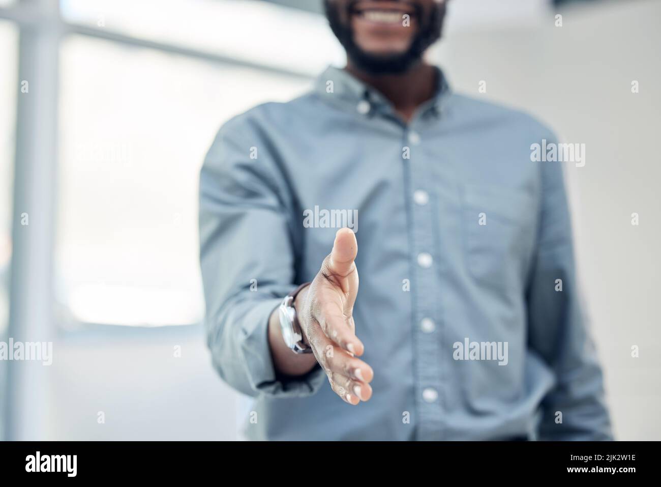 Lets collaborate. an unrecognizable businessman standing alone in his ...