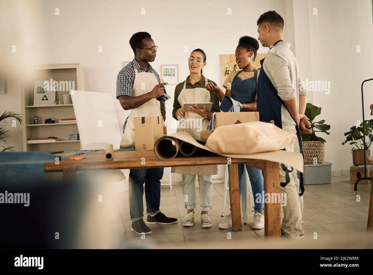 Group of designers doing design teamwork while talking and working on a ...