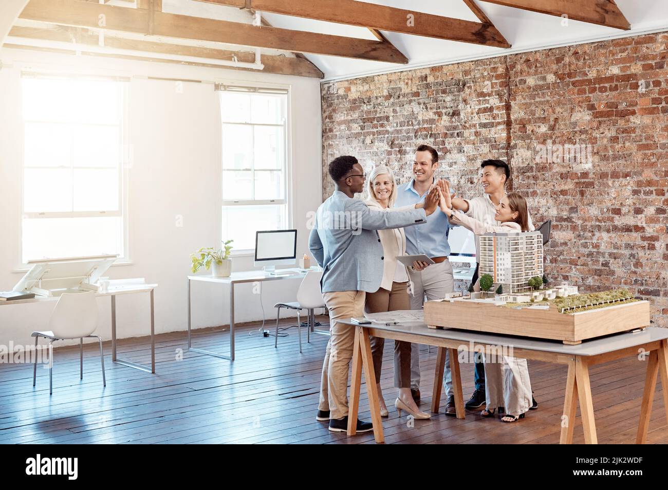 Team of happy architect engineers celebrating together with a high five ...