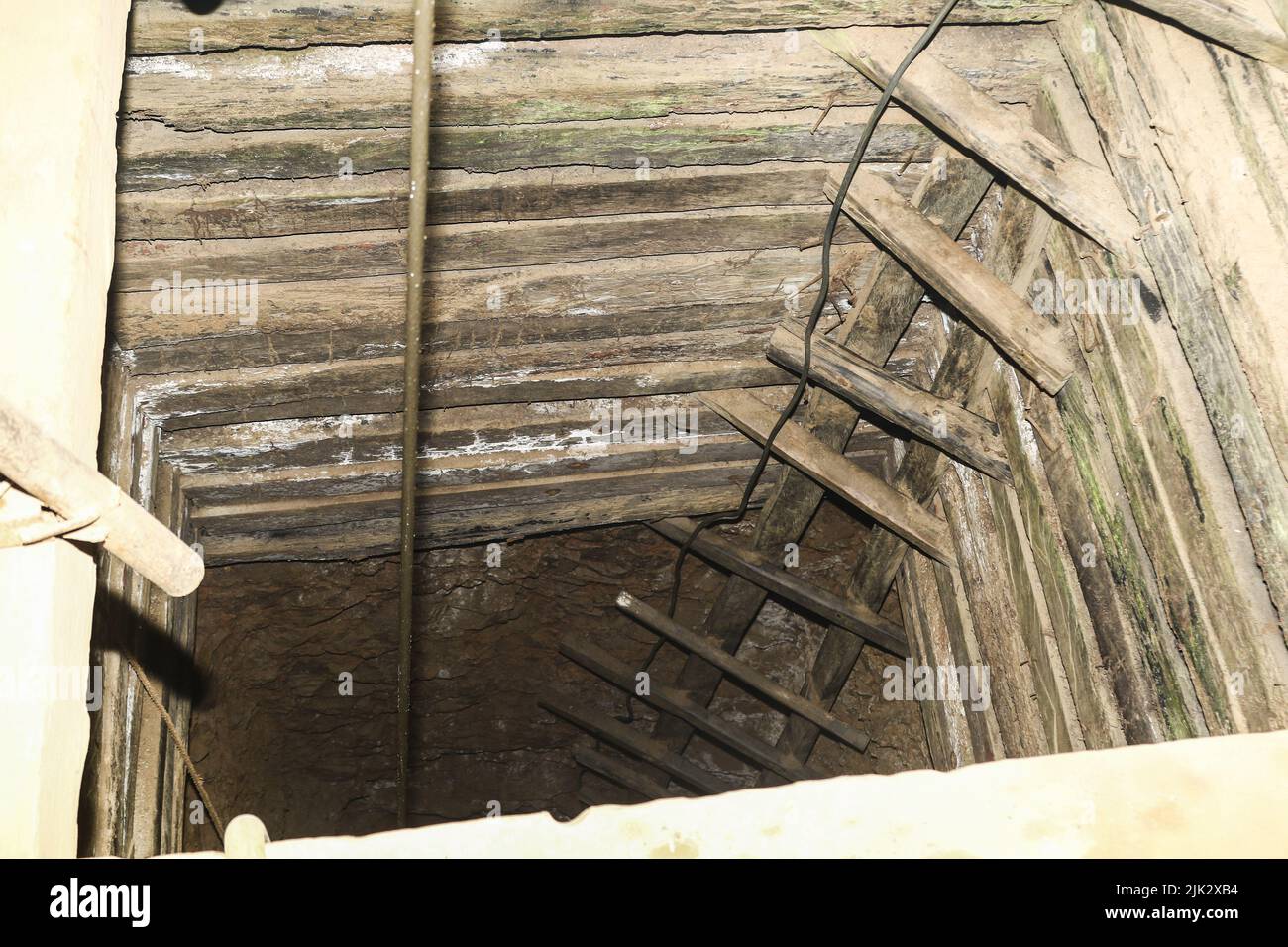 A view of a vertical shaft with a wooden ladder that miners use to ...