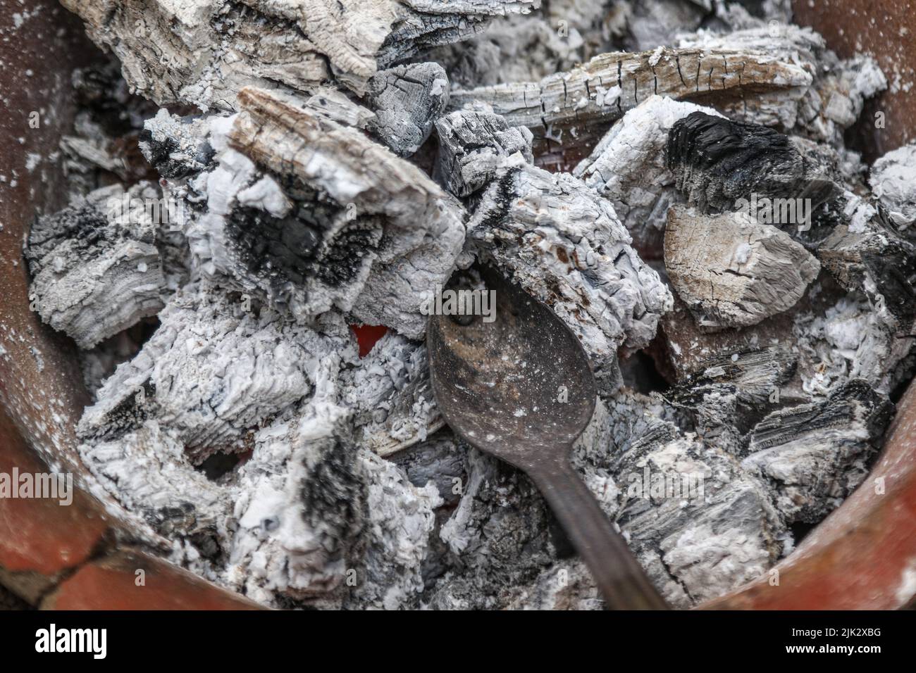 A piece of gold is seen being heated in a charcoal fired oven to remove ...