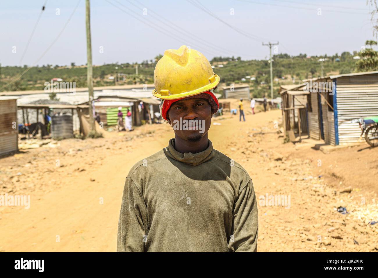 A miner in a helmet poses for a picture at the mining area before ...