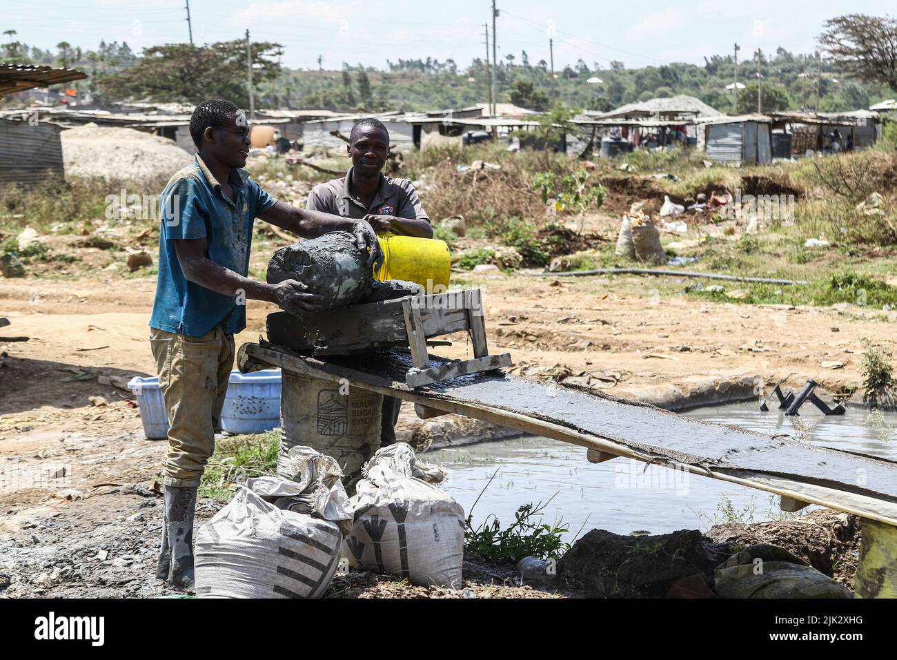 Men are seen mixing crushed ore with water to make a concentrate at the ...