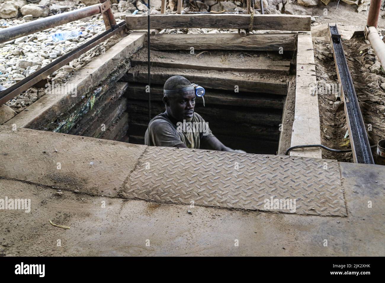 An artisanal miner is seen emerging from a shaft at a gold mine in ...