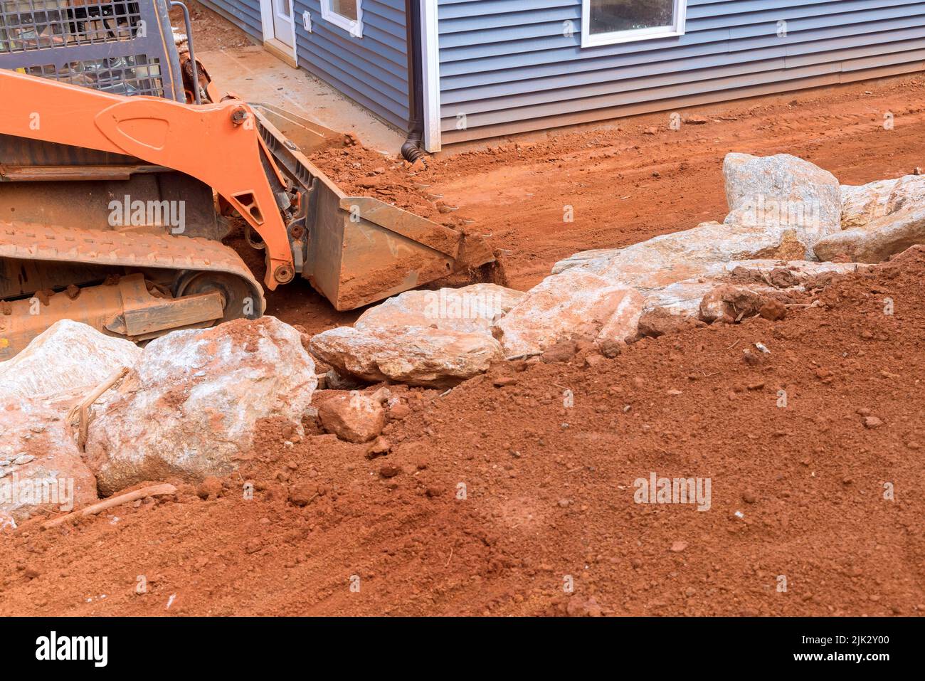 During the landscaping work on construction site, a bulldozer performs ...