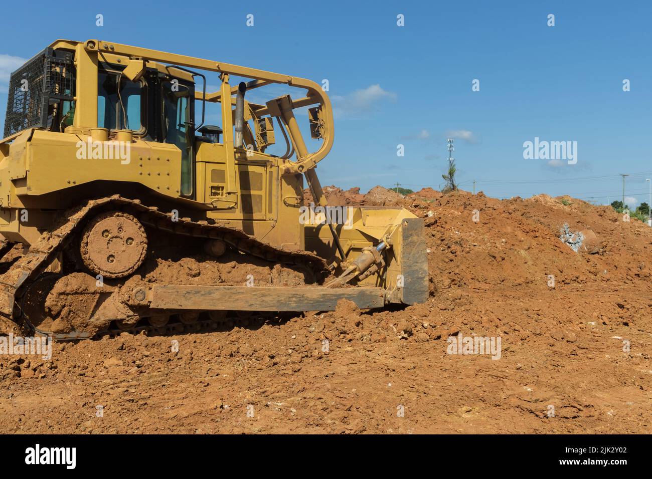 While doing landscaping work on a construction site, a bulldozer works ...