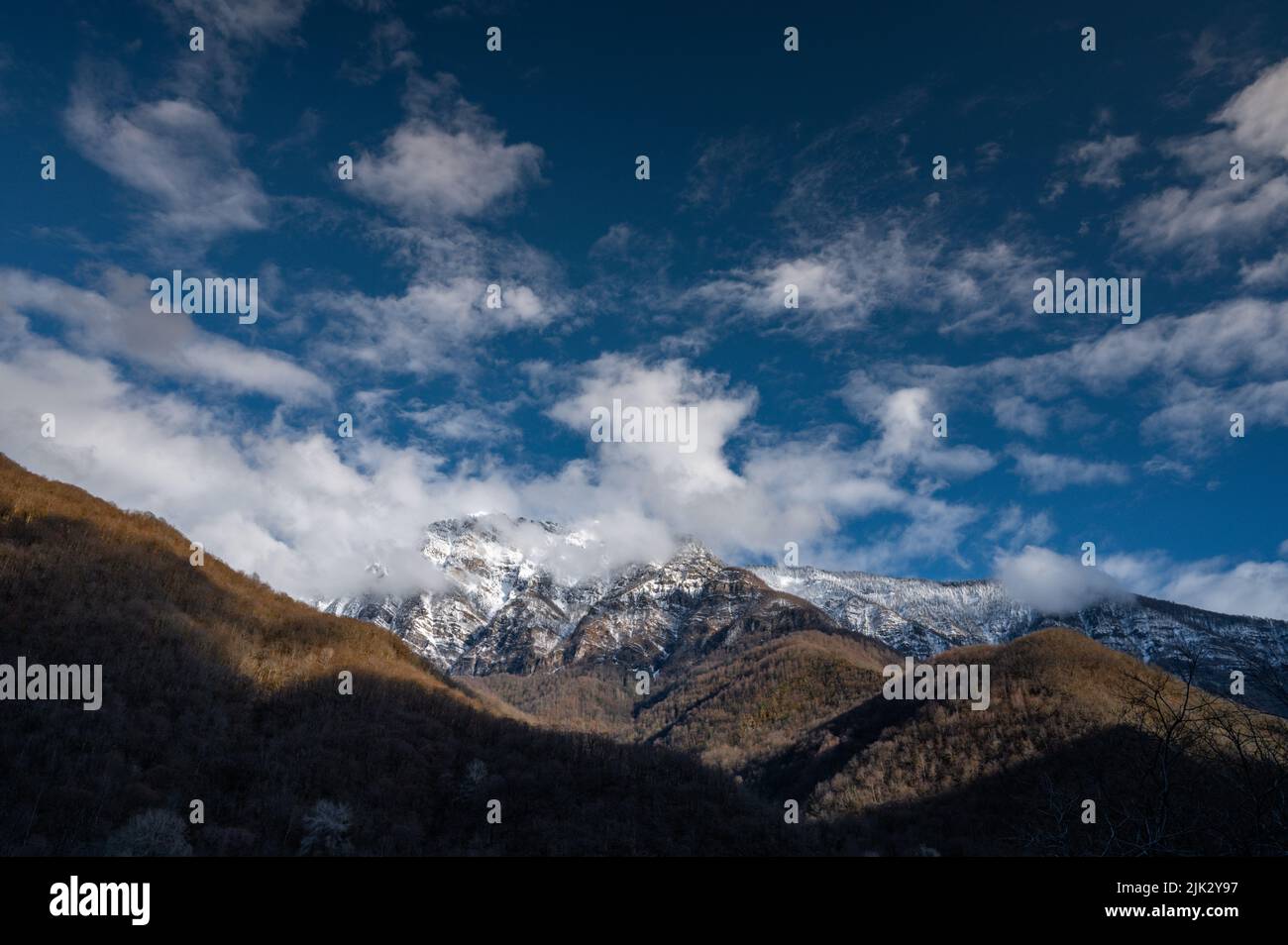 Beautiful scenic view on snow peaks in the distance.Blue sky with ...