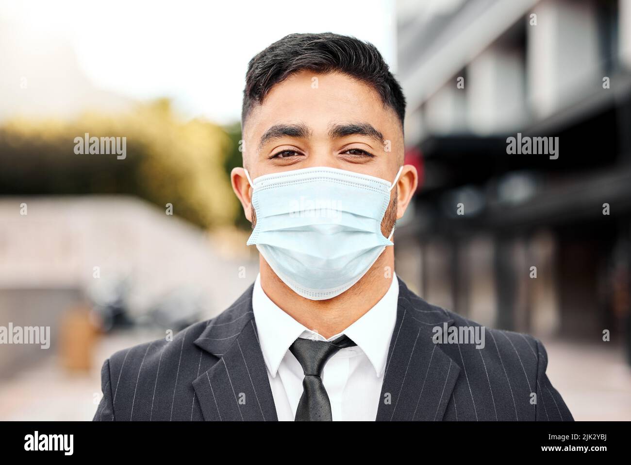 Be safe when youre outside. a young businessman wearing a protective ...