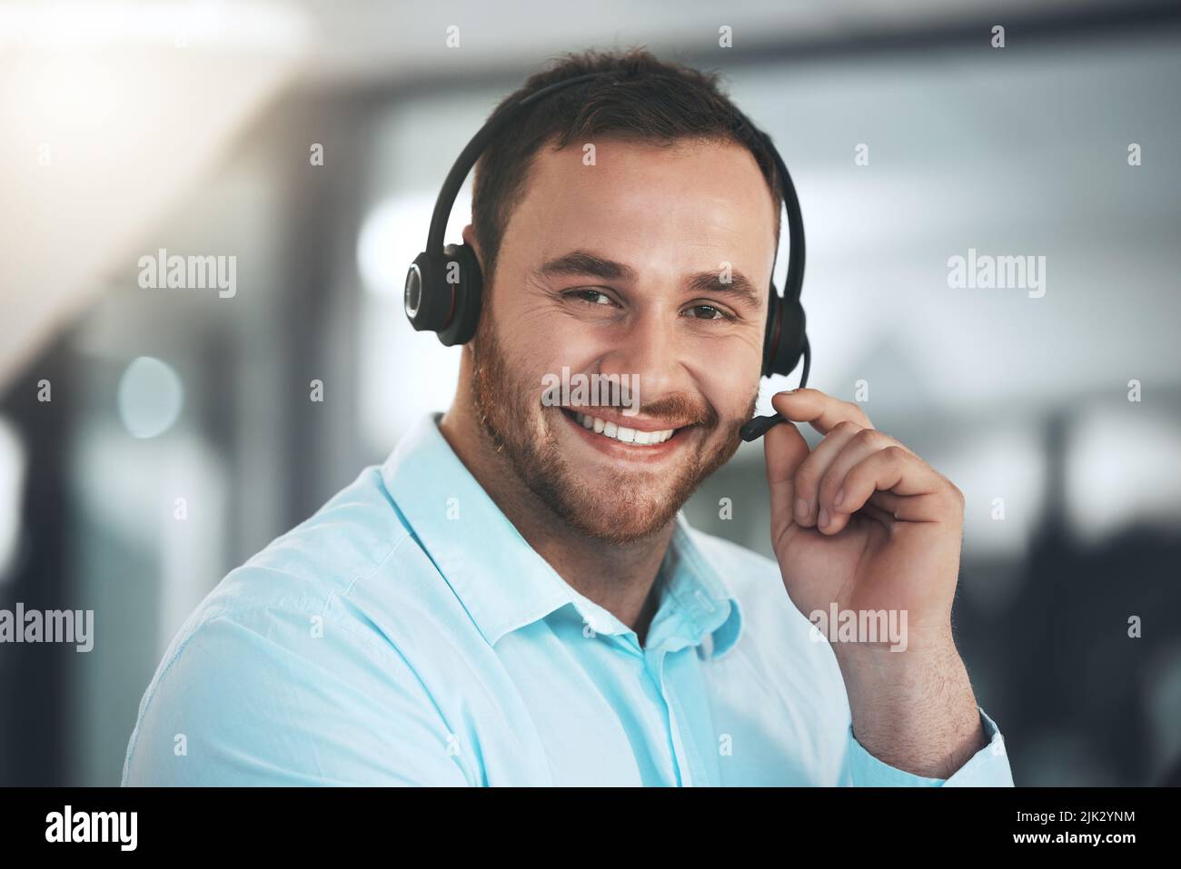Give us a call if you need help. a young call centre agent sitting ...