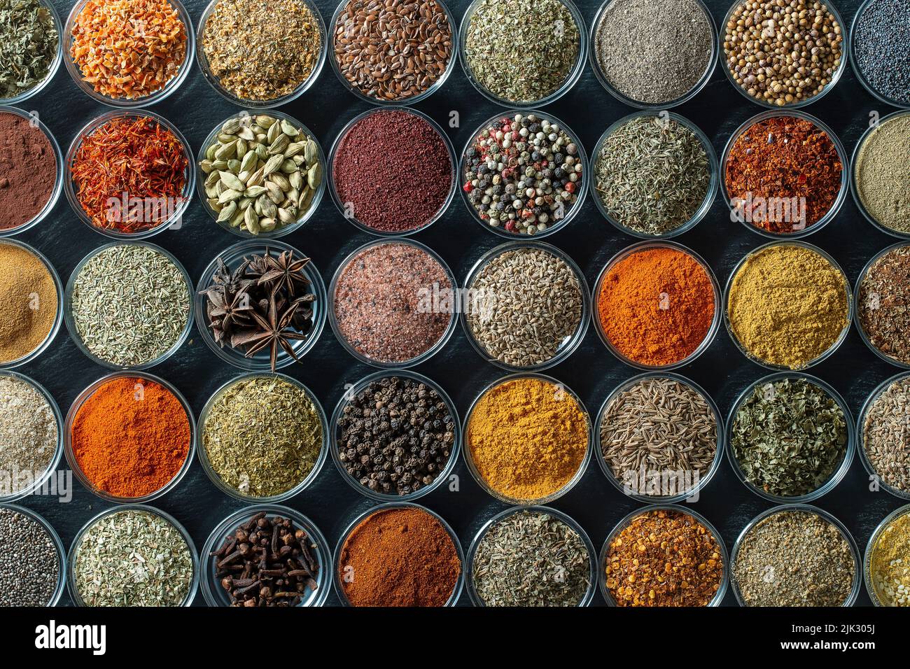 Assortment of aromatic spices, seeds and dry herbs for cooking food on ...