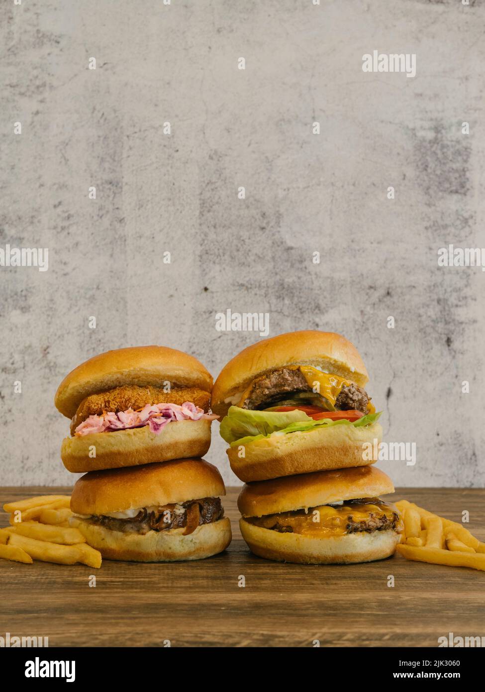 four burgers stacked two up with fries on the side Stock Photo - Alamy