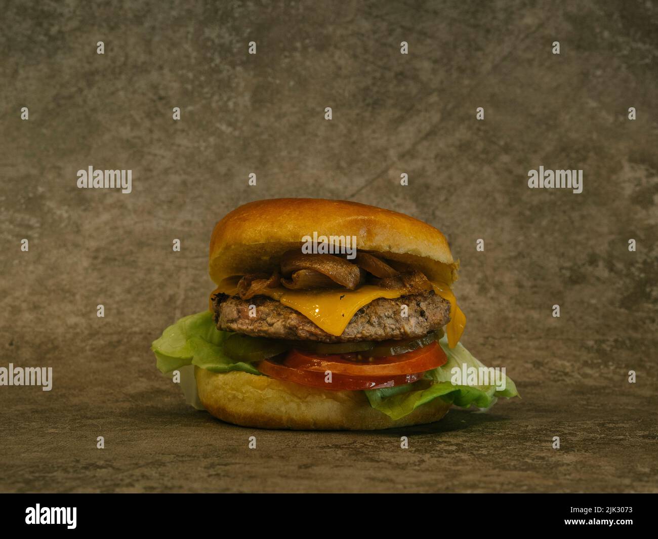 Single cheese burger with caramalised onions and lettuce and cheese ...