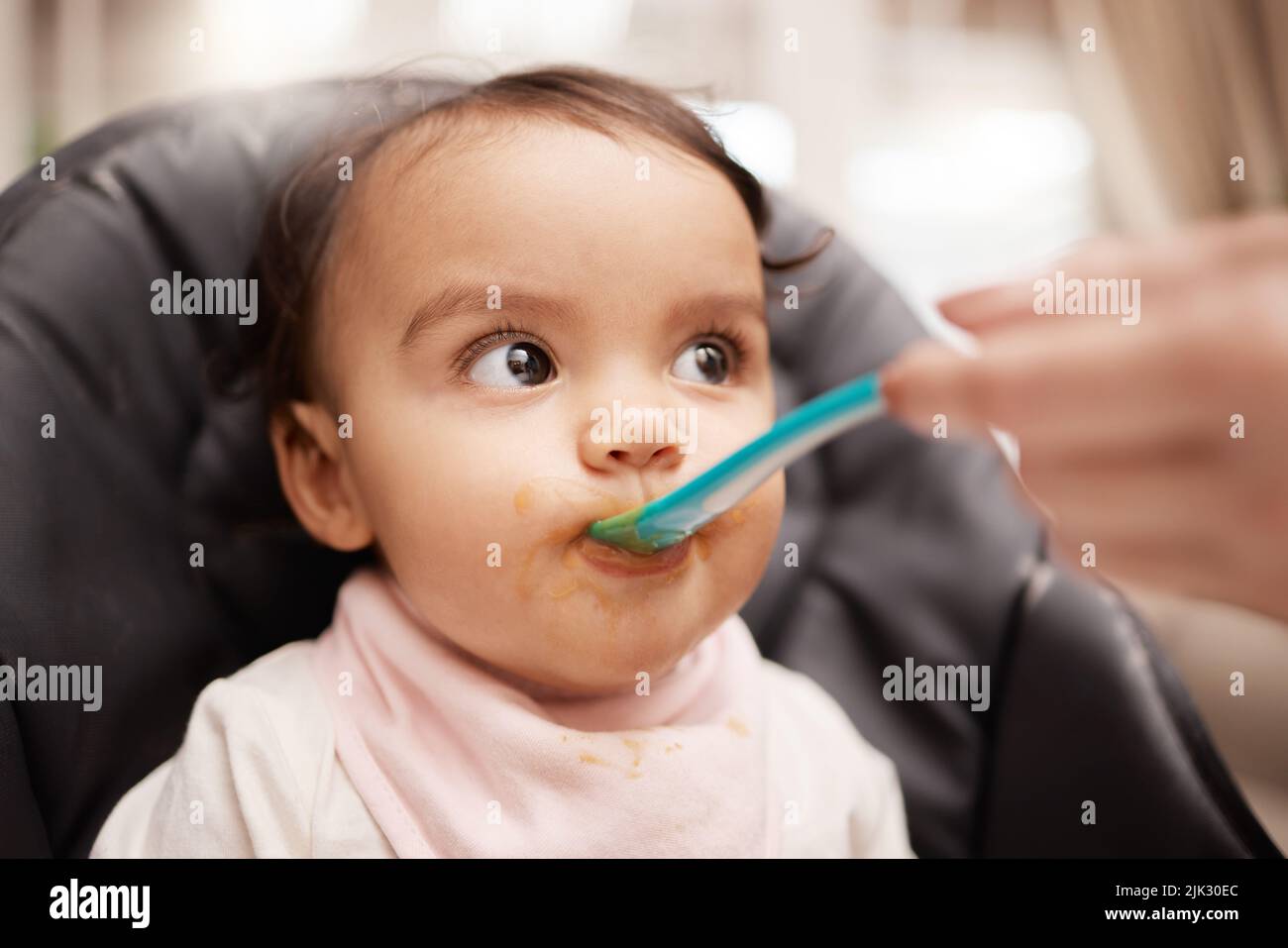 Did you taste this. an adorable baby girl eating her food Stock Photo ...