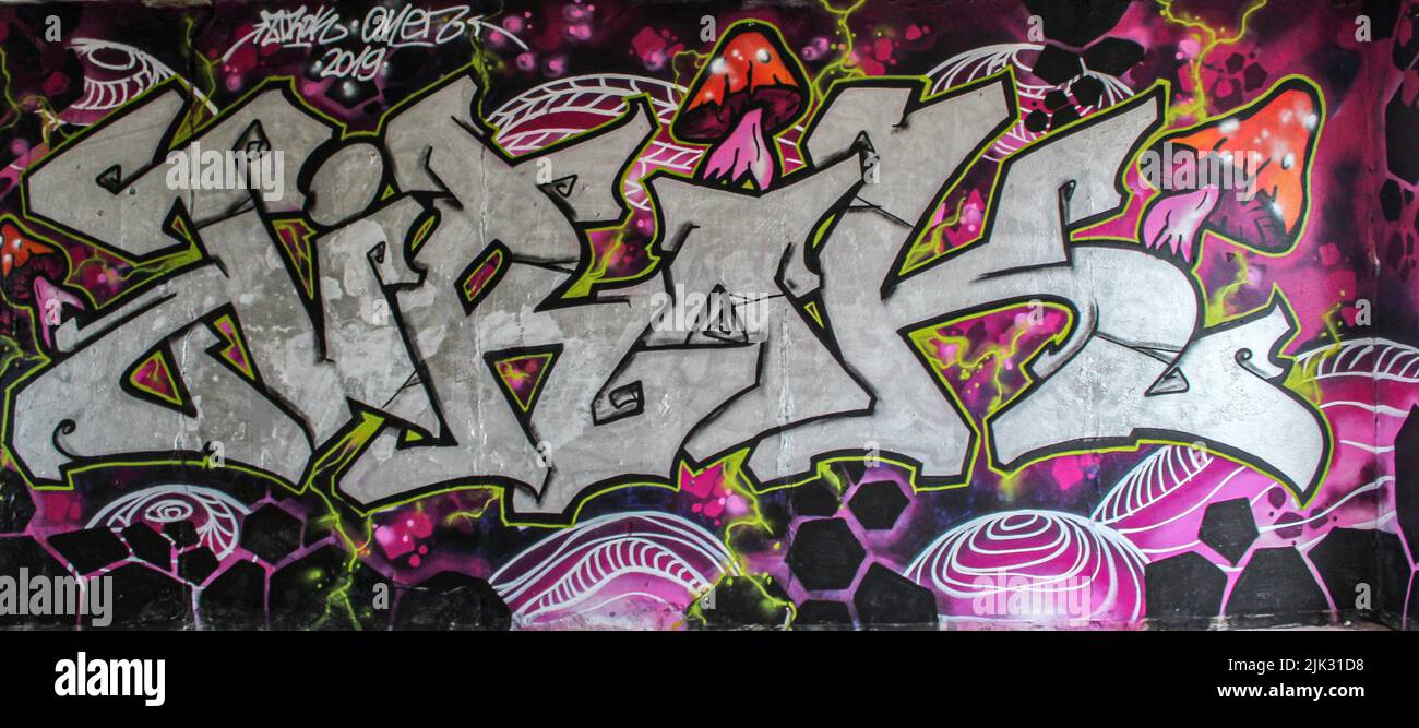 colorful abstract wildstyle graffiti painting or artwork on a wall with ...