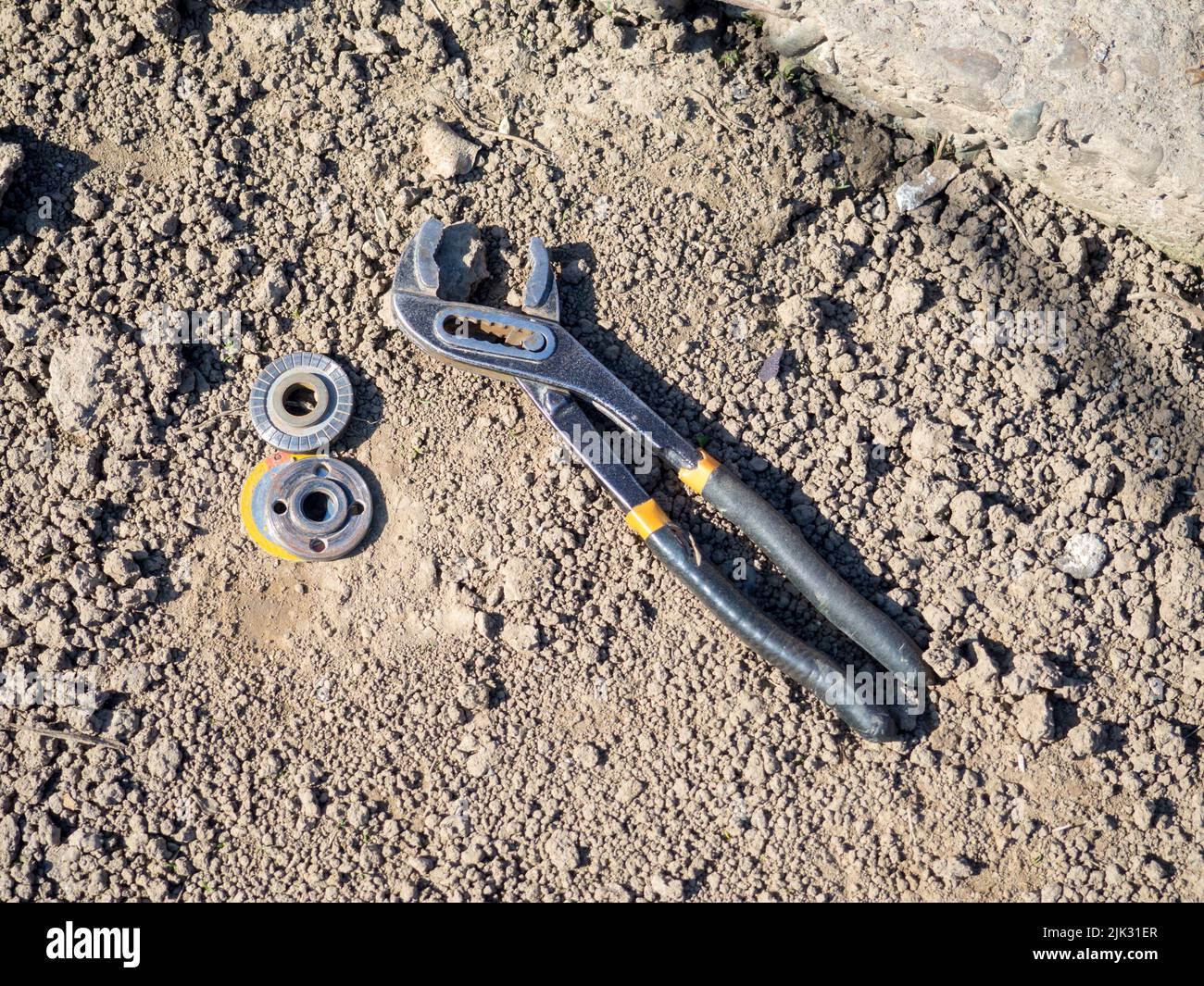 wrench or tongue-and-groove pliers and bearings on the ground Stock ...