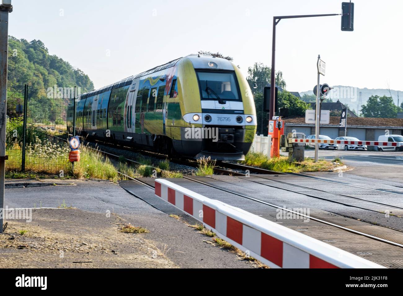 Train circulating on crossing with a road, the safety barrier is down ...